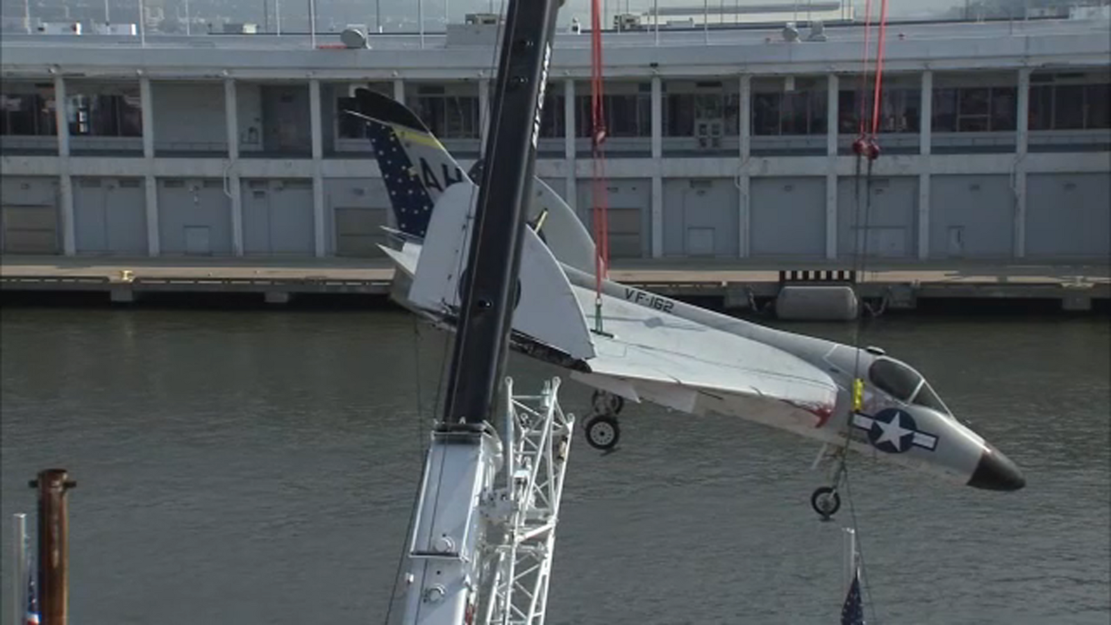 Douglas F4D Skyray aircraft lifted by crane onto to the Intrepid after ...