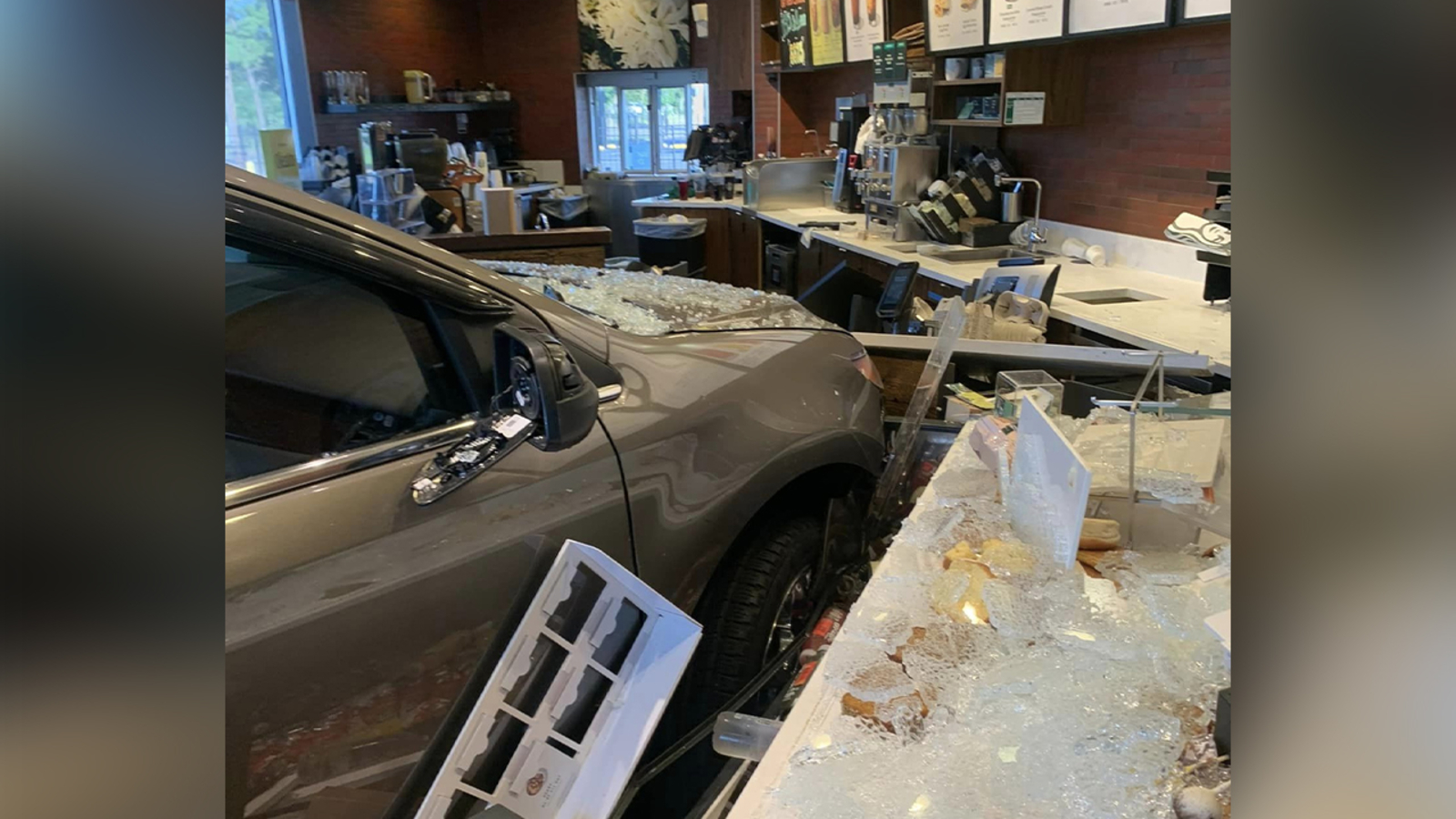 Car hits building: Starbucks barista injured after truck crashes onto ...