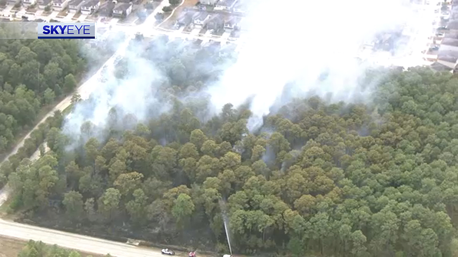 Crews working to put out grass fire near neighborhood in northeast ...