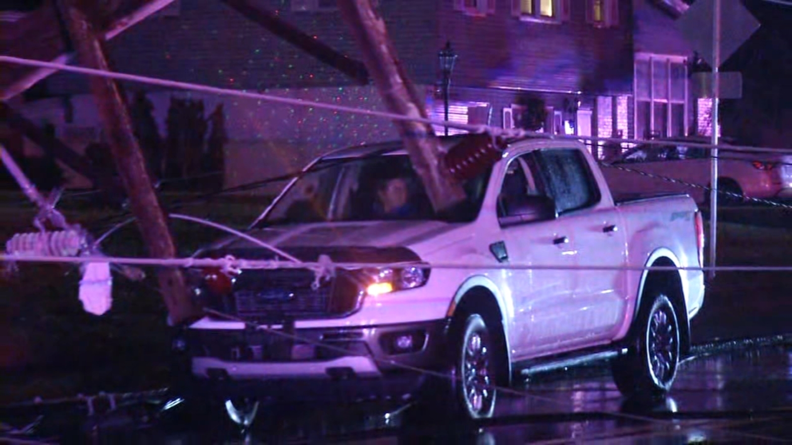 2 people trapped after live power lines come down on top of vehicle in ...