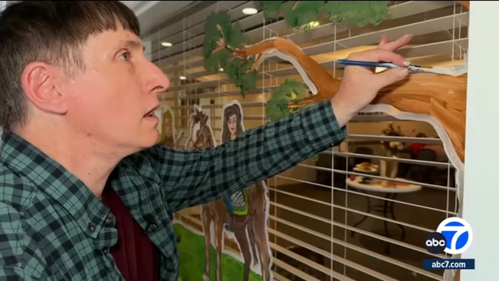 Local artist Greg Sutton continues to create window paintings despite ...
