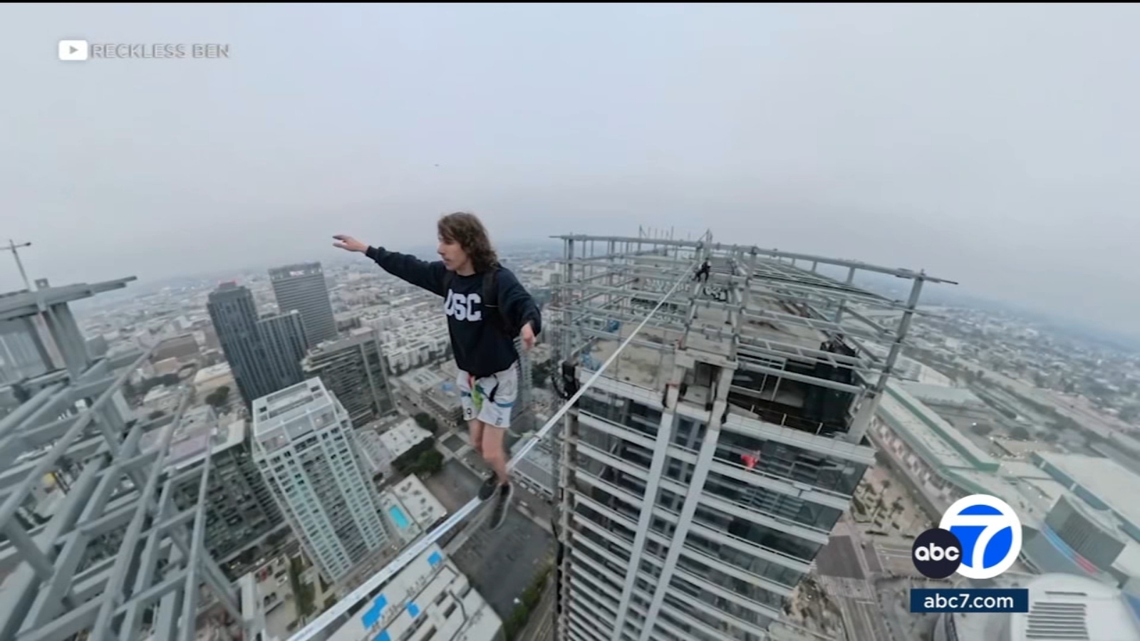 Daredevil Ben Schneider walks tightrope between 'graffiti towers' in ...