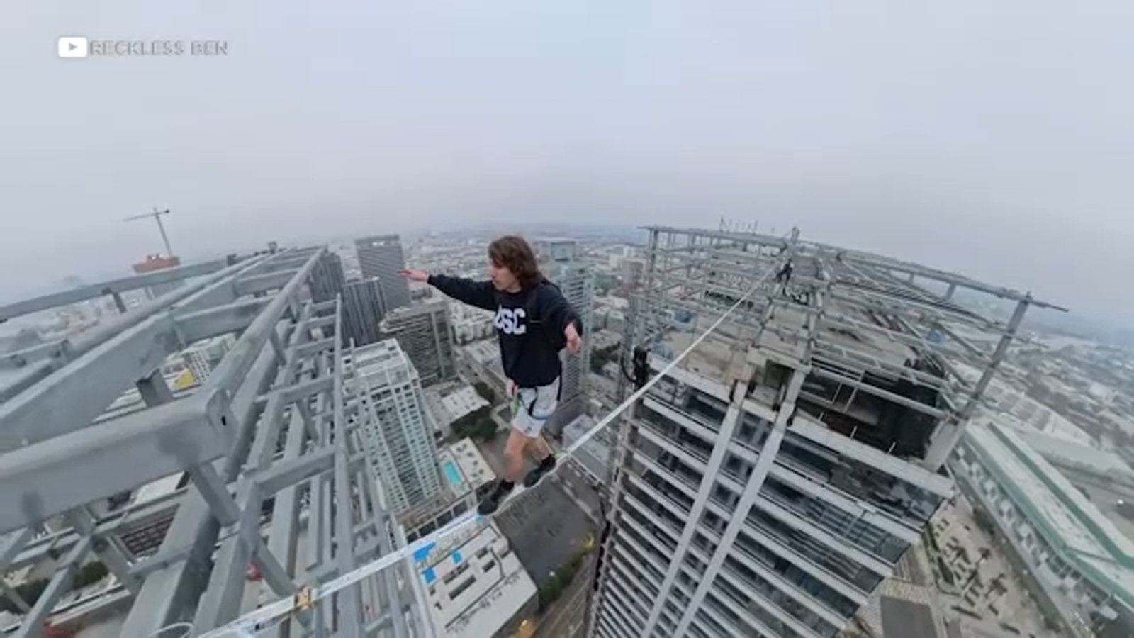 Daredevil Ben Schneider walks tightrope between 'graffiti towers' in ...