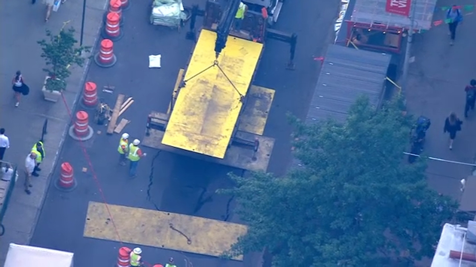 Street collapses in Greenwich Village, Manhattan; crews cover roadway ...