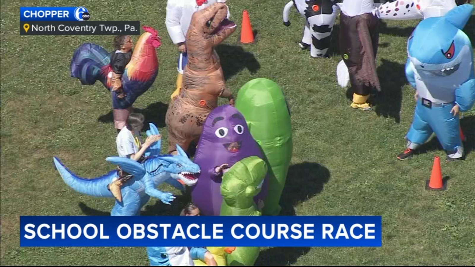 Teachers flop across the finish line during inflatable costume race at ...