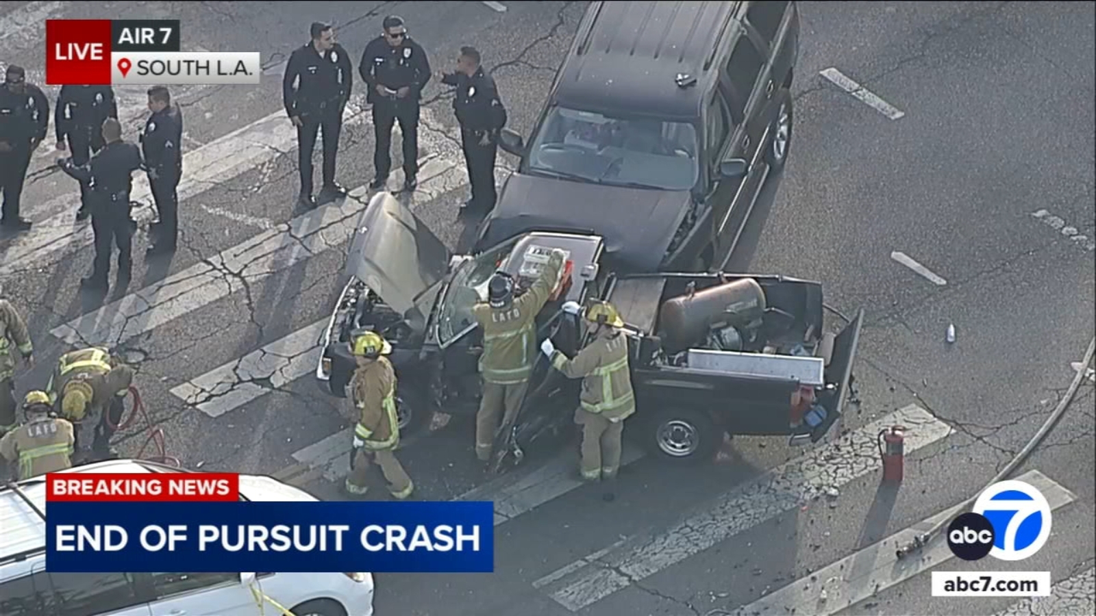 Domestic violence suspect fleeing LAPD smashes into pickup at South LA intersection, trapping ...