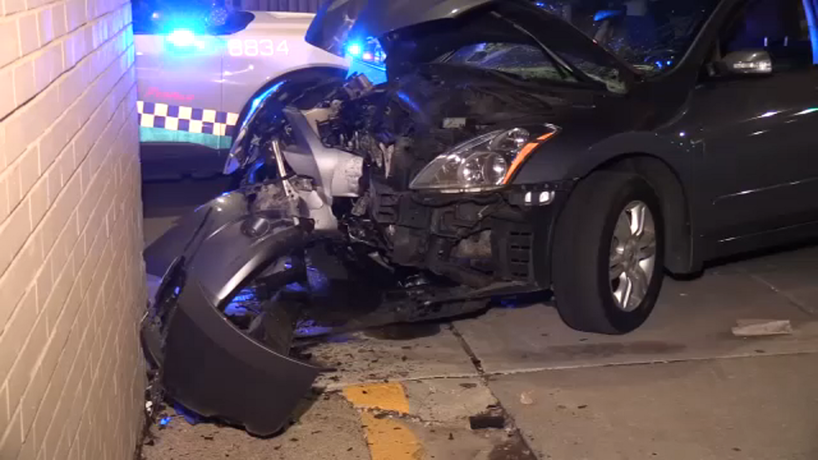 Driver critically injured after car crash into apartment building near ...