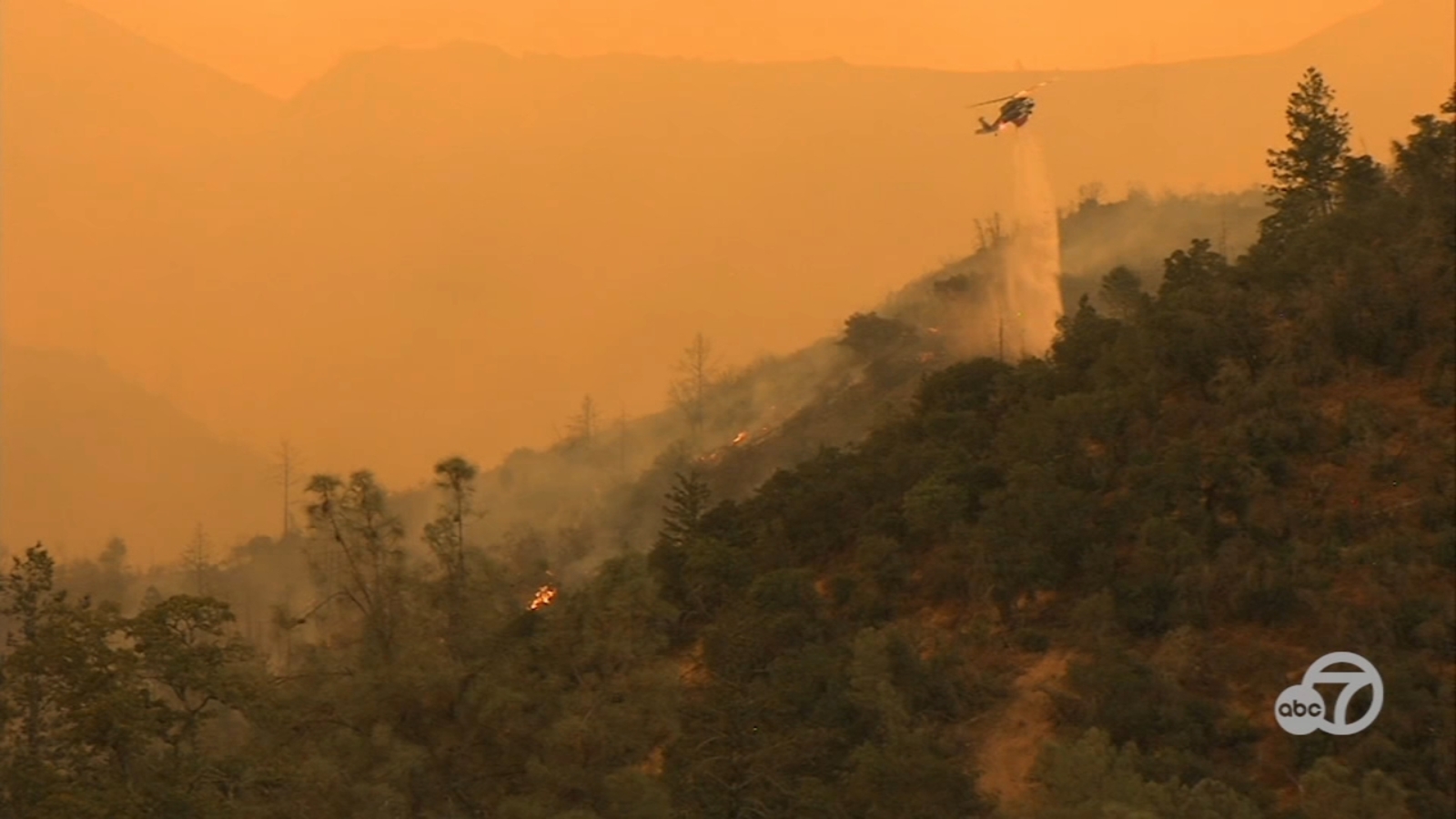 Firefighters dealing with smoky, hot conditions and challenging terrain ...