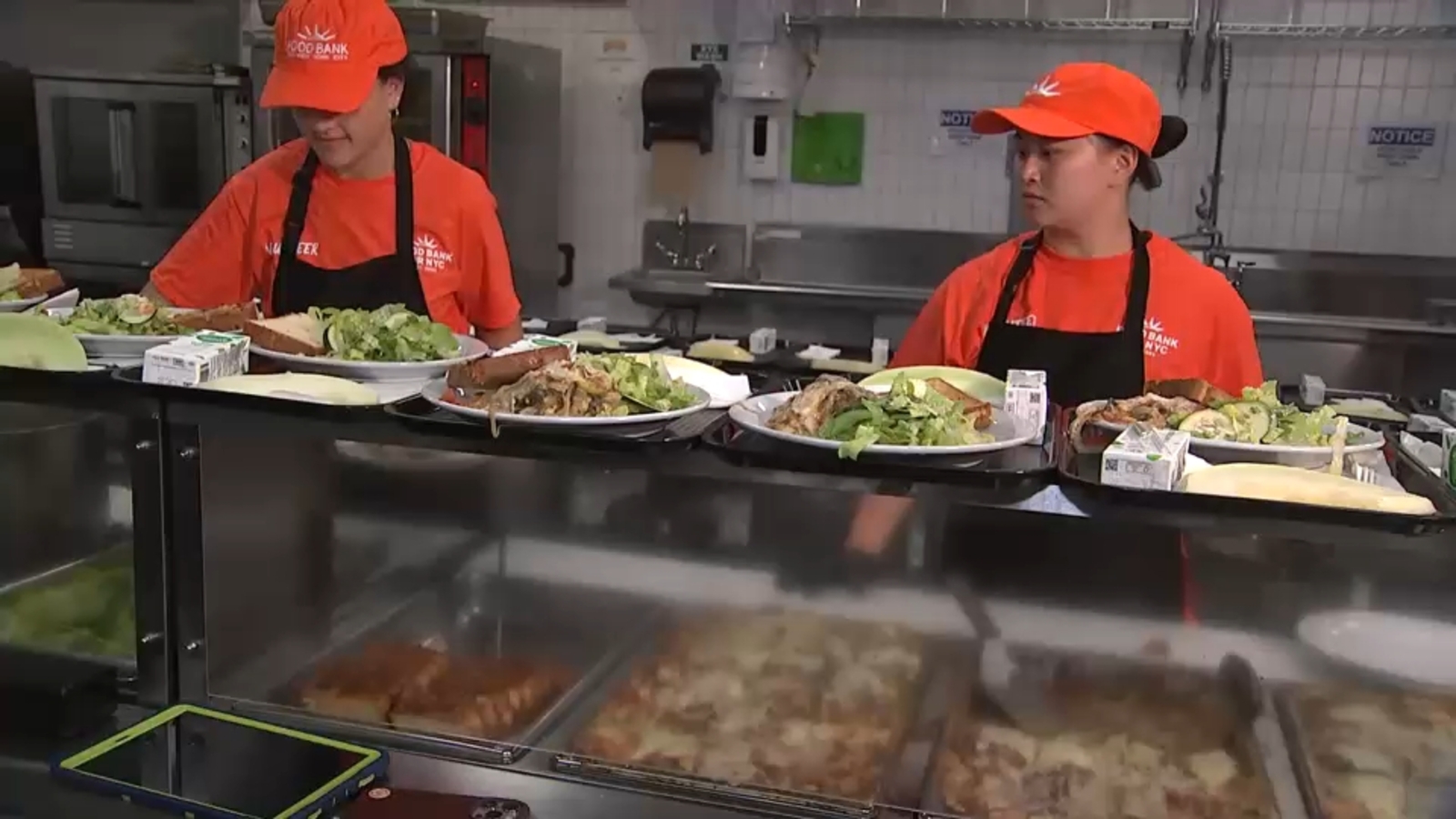 Staff and volunteers serve meals to seniors in West Harlem, NYC on ...