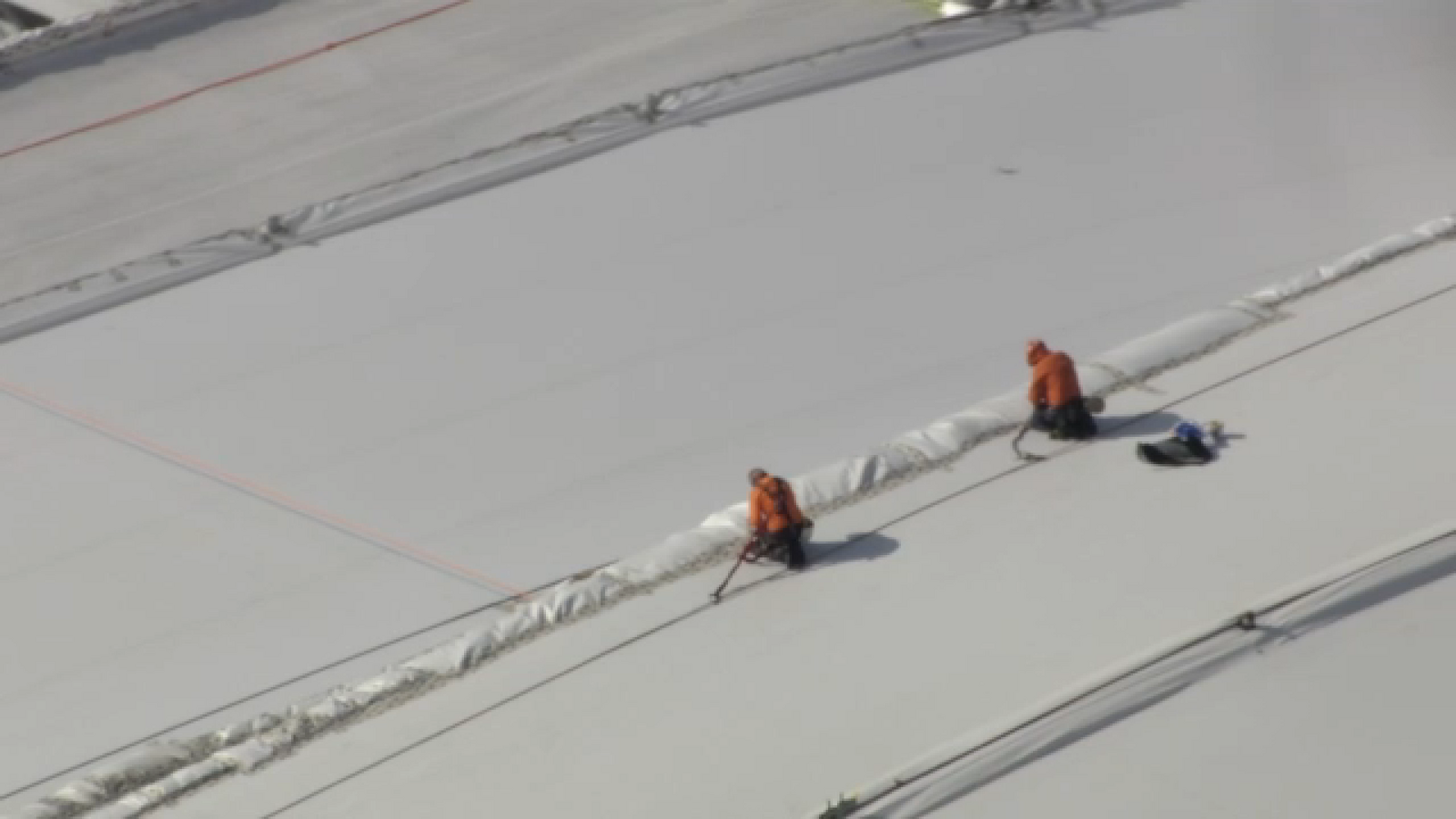 Crews seen working on NRG Stadium roof after water pours into venue ...