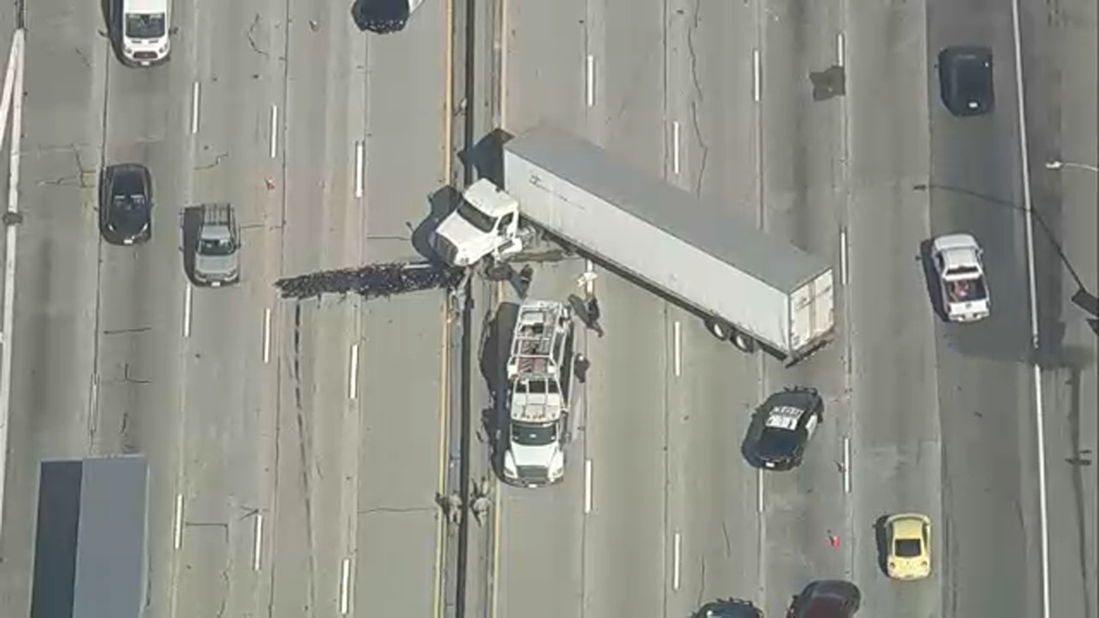 Jackknifed big rig blocks lanes on both sides of 210 Freeway in Azusa ...