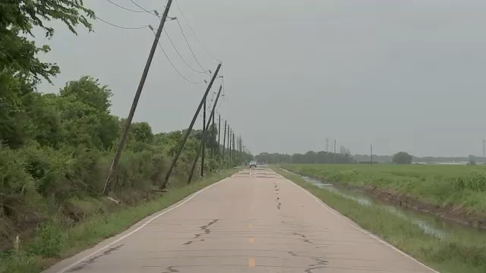 Images show power poles leaning over Brazoria County road, neighbors ...