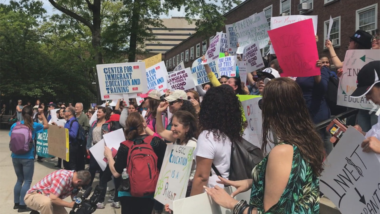 Hundreds protest potential cuts to adult literacy programs in Queens ...