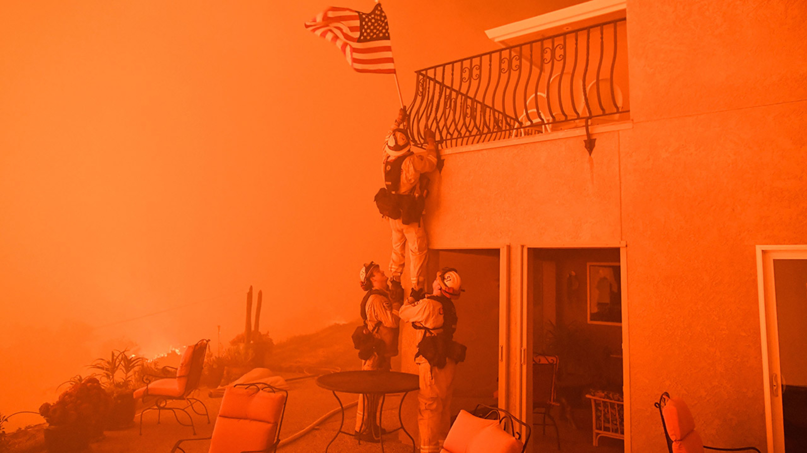 Inspiring moment shows firefighters rescuing American flag from ...