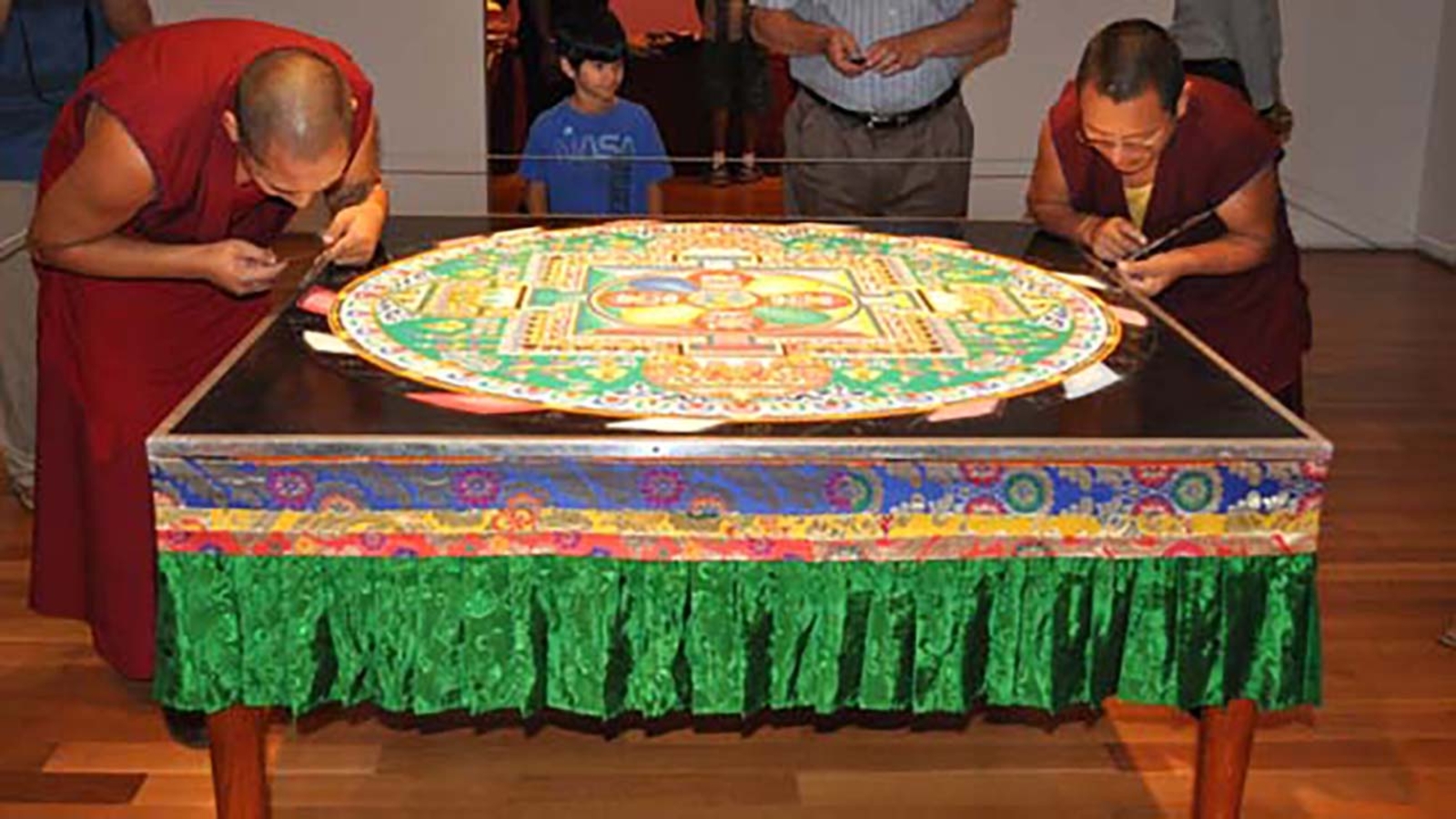 Tibetan monks creating colorful sand mandala in Houston - ABC13 Houston