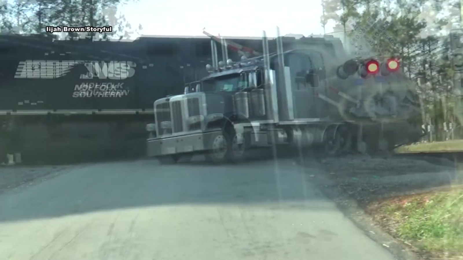 Caught on video: Truck driver escapes semi before it's hit by a train ...
