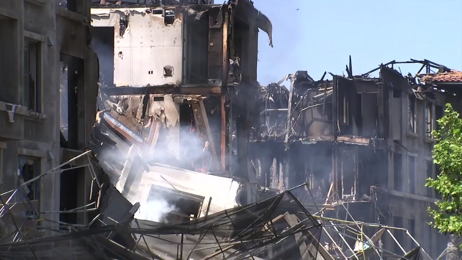 Massive fire still smoldering at apartment building under construction ...