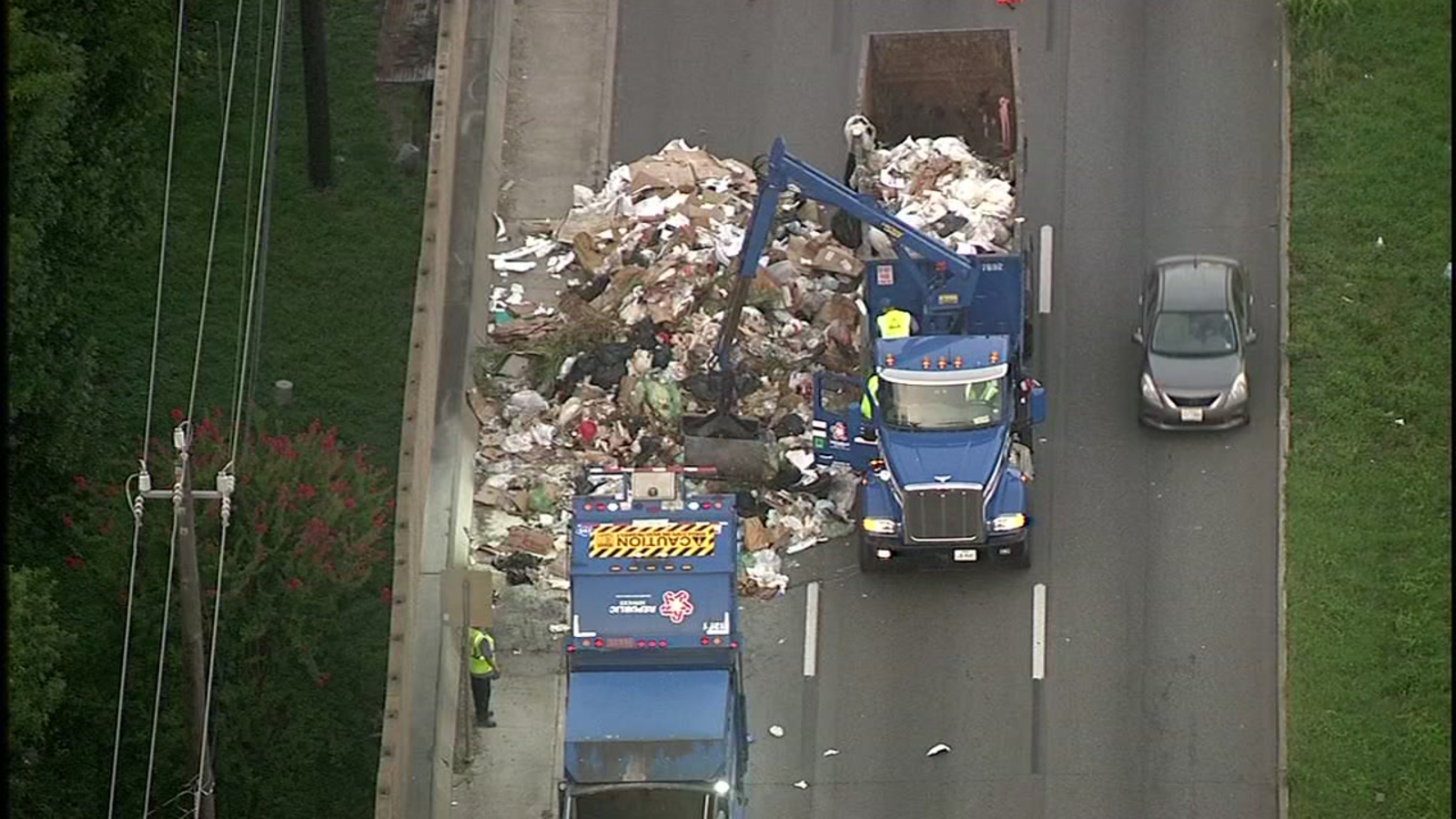 Lost load from trash truck blocked Southwest Freeway feeder road ...
