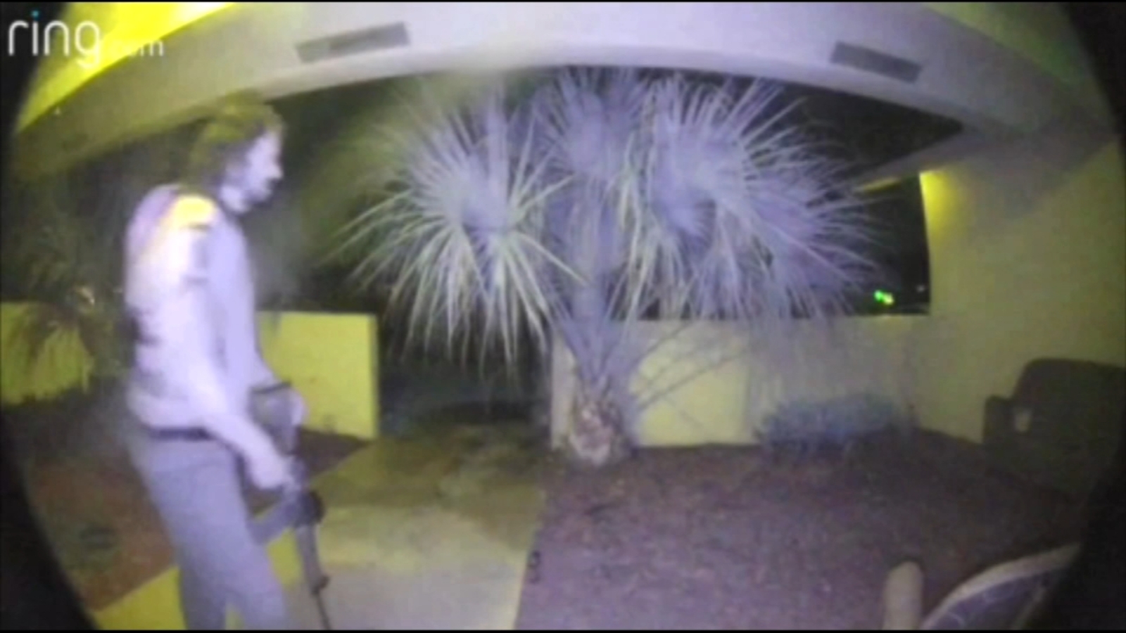 Man Armed With Assault Rifle Captured On Surveillance Video Ringing