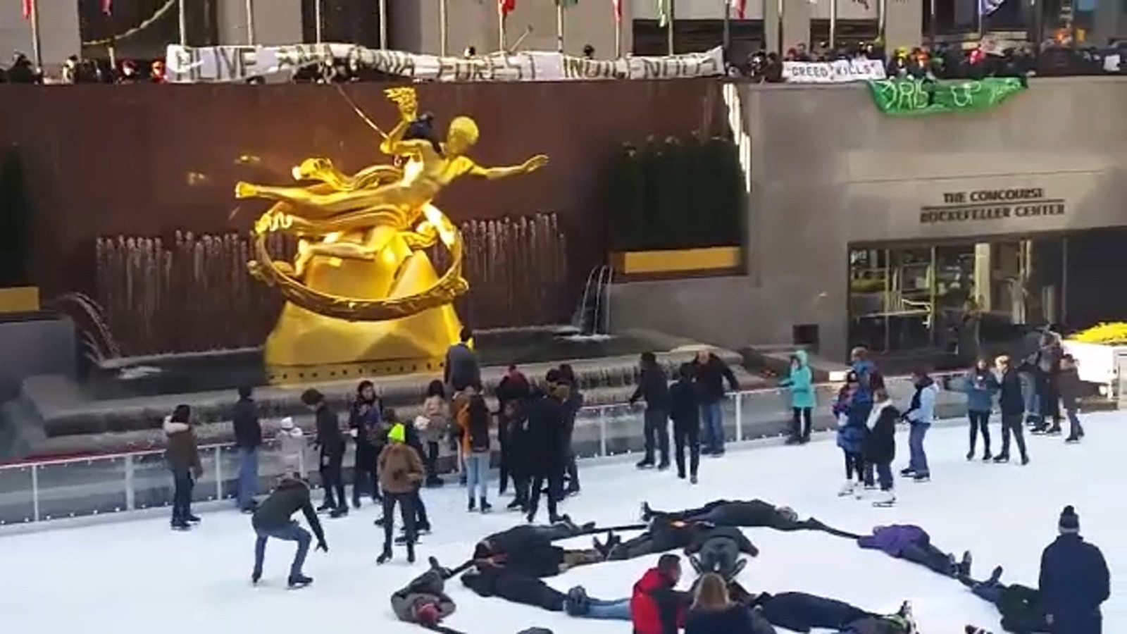 Climate change protesters climb gold statue at Rockefeller Center; 9 ...