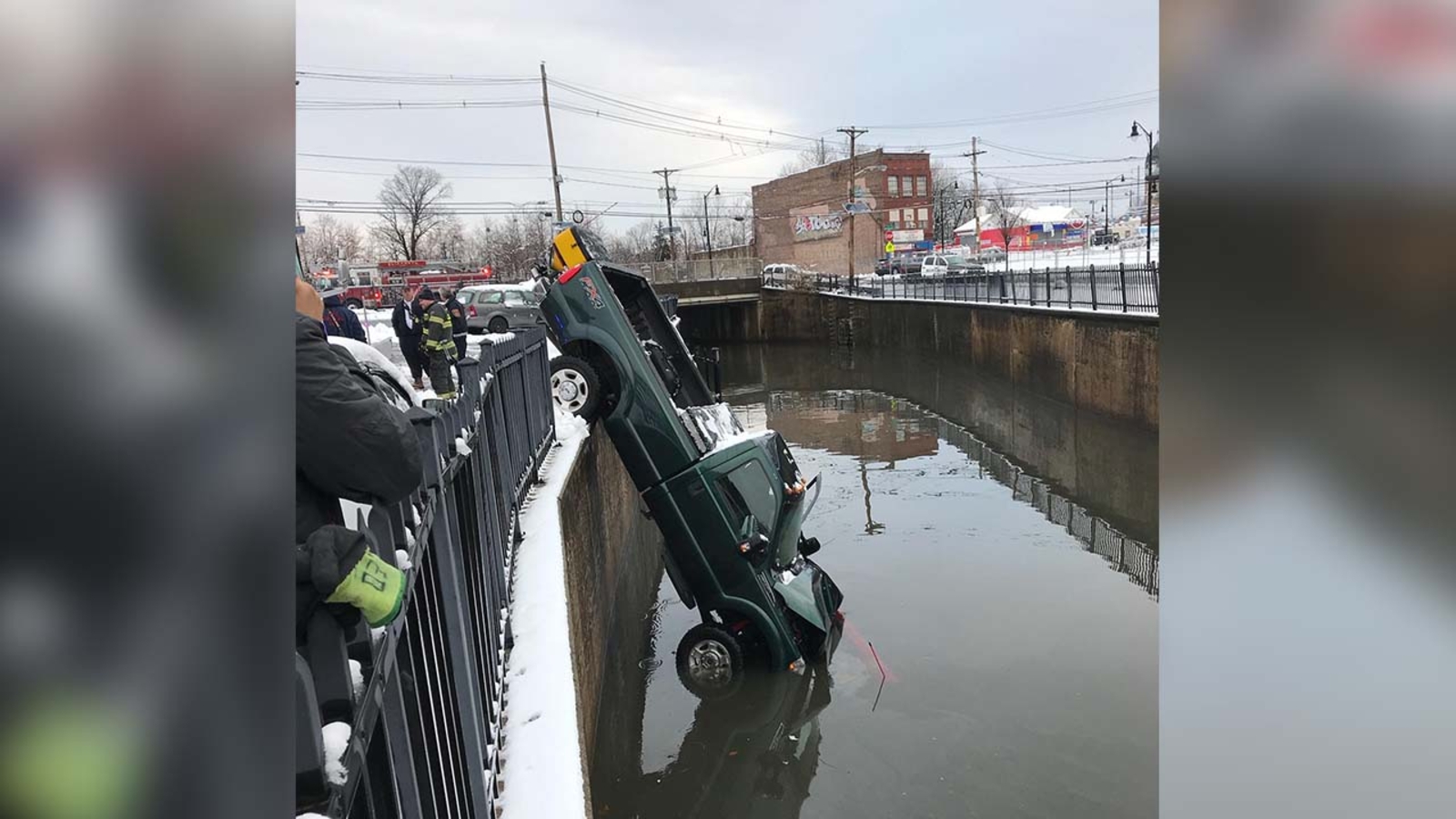 Plow truck skids off ledge and dangles into Arthur Kill River in ...