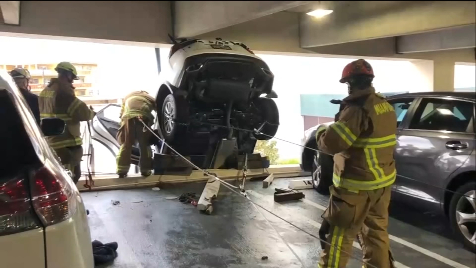 Woman rescued from car dangling from Miami parking garage - 6abc ...