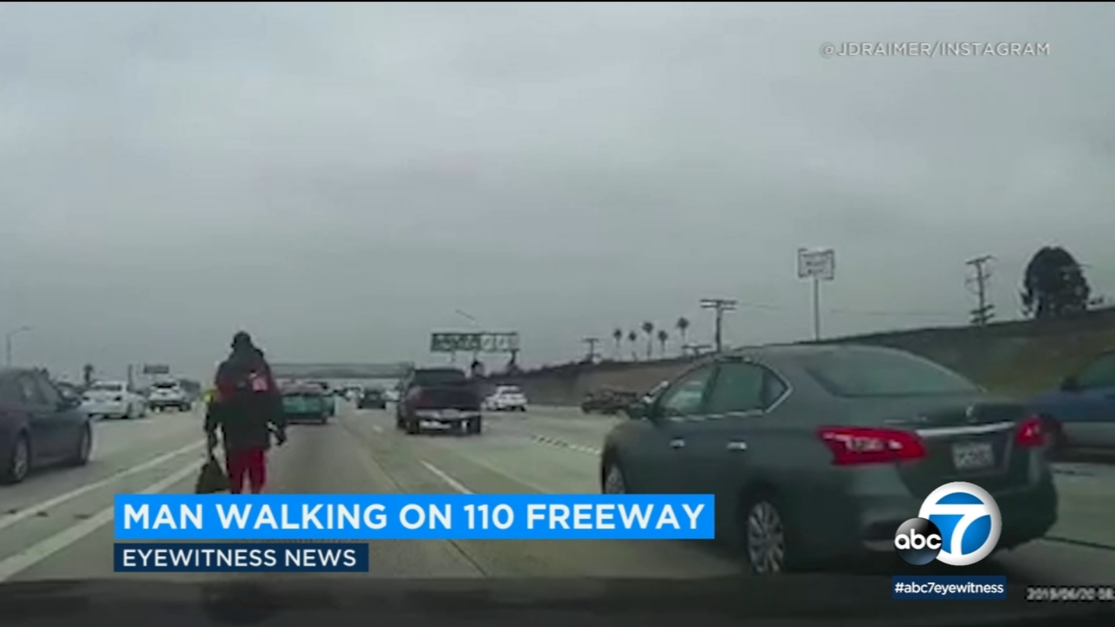 ONLY IN L.A.: Man with headphones strolling in lanes of 110 Fwy during ...