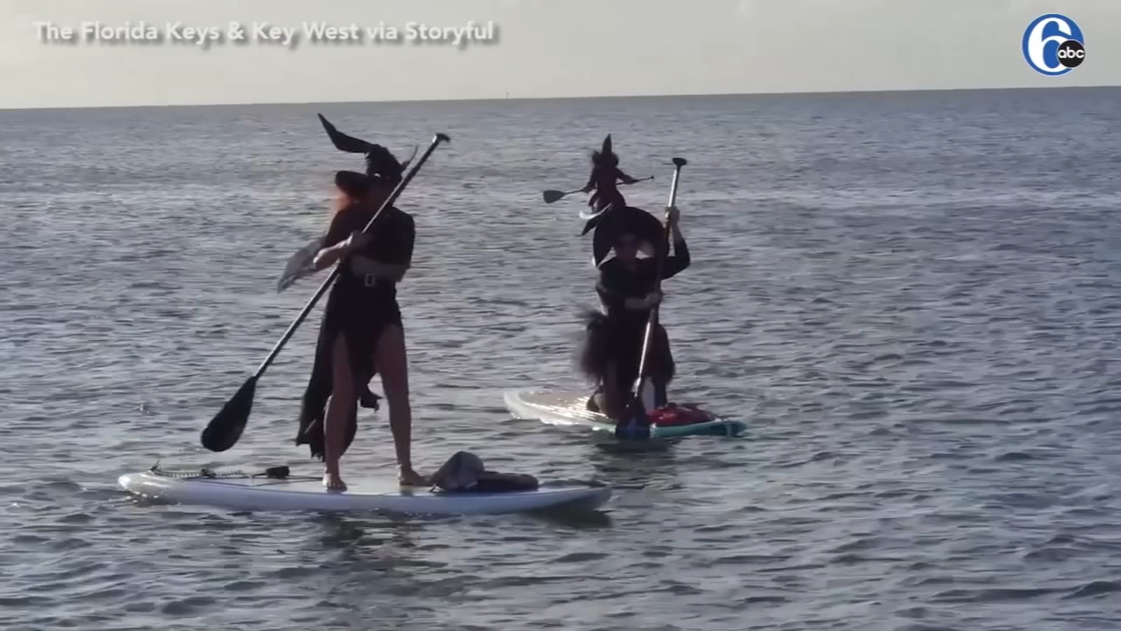 Paddleboarding witches celebrate October full moon in Florida Keys ...