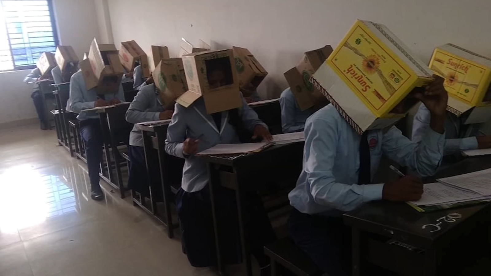 Indian students wear boxes on their heads during exam to prevent ...