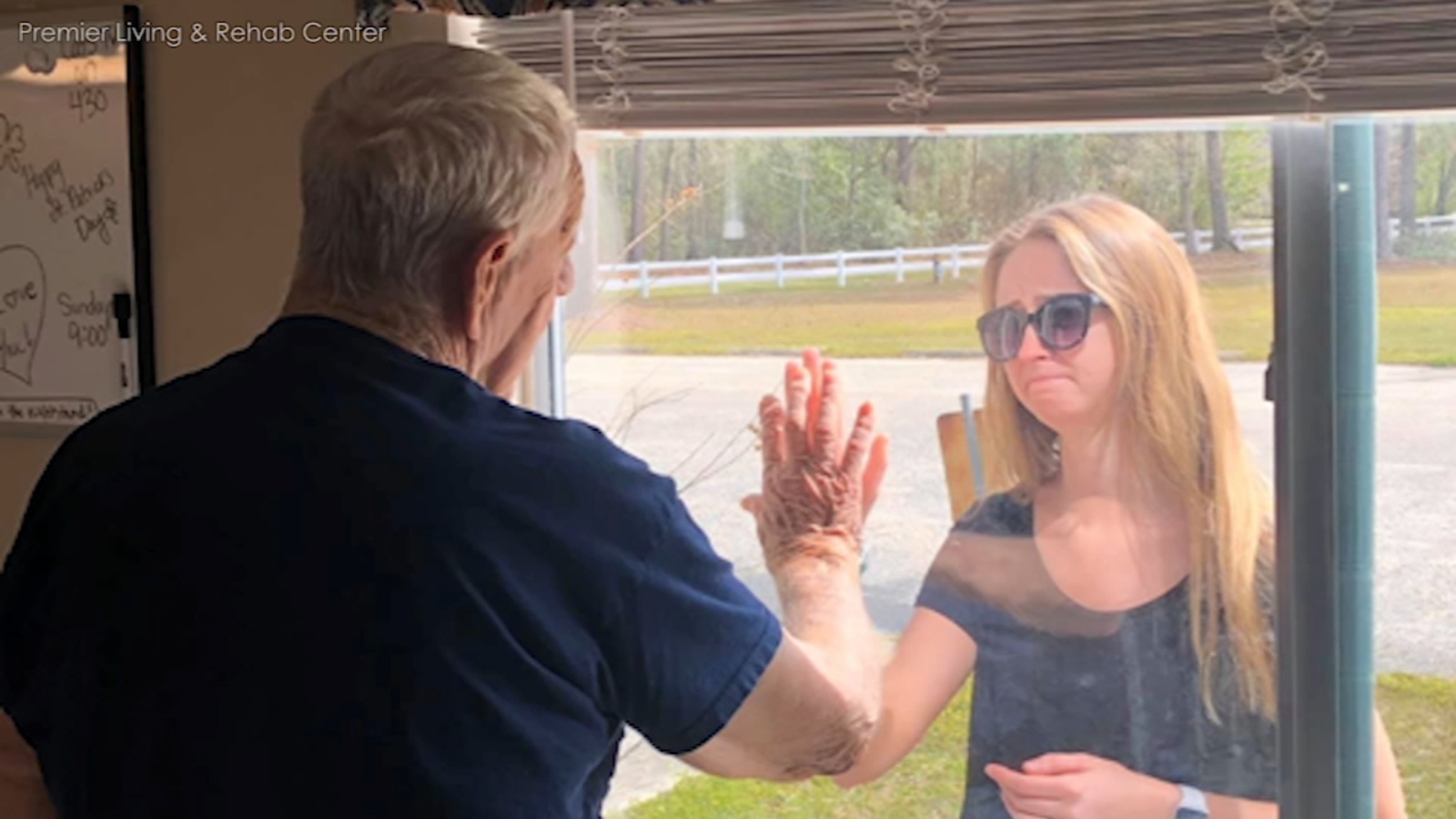Woman announces engagement to grandpa through his nursing home window ...