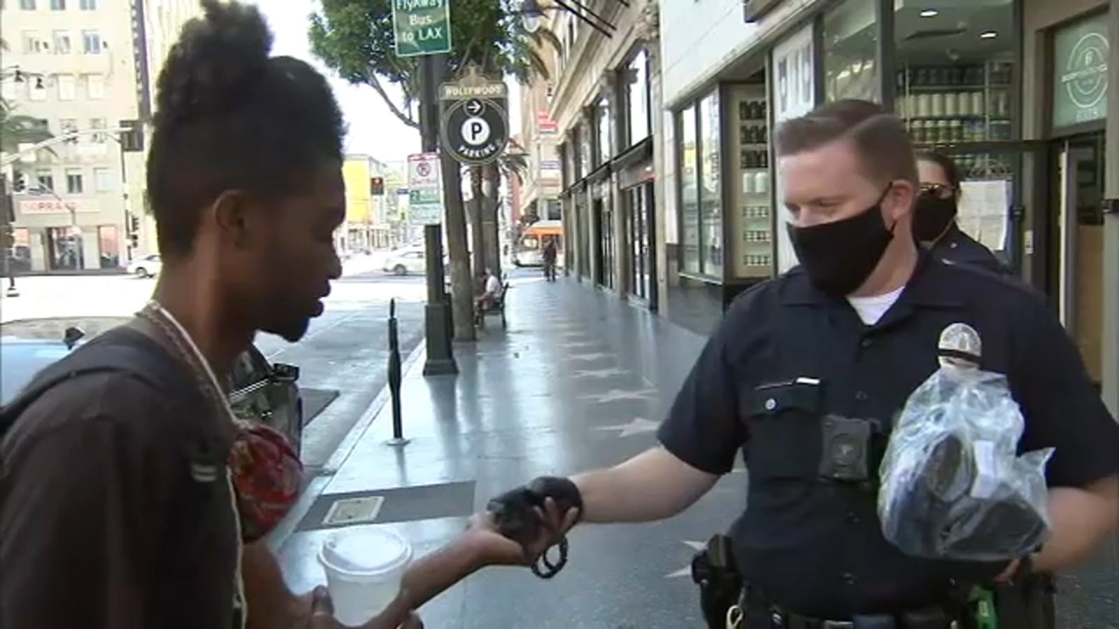 COVID-19: LAPD officers hand out hundreds of face masks in Hollywood ...