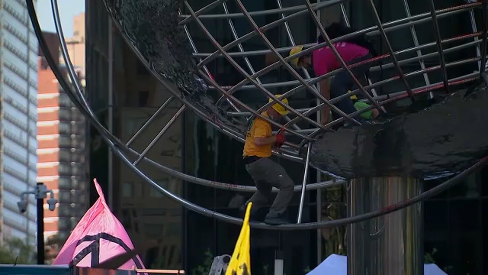 Climate change protesters scale Columbus Circle globe on Upper West ...