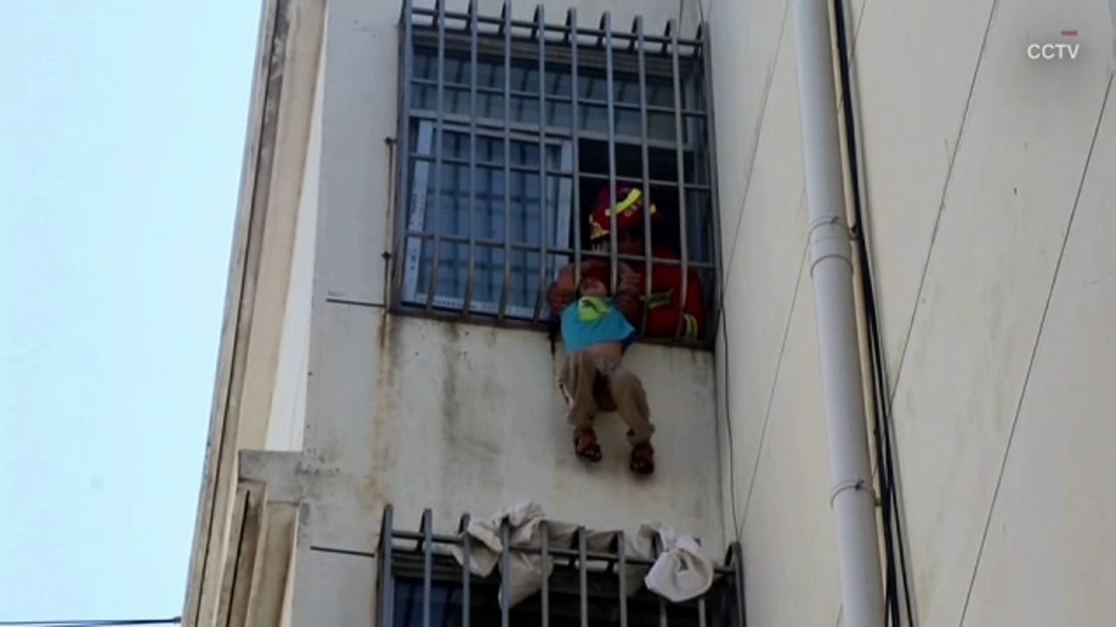 Firefighters rescue boy dangling by head after getting trapped in ...